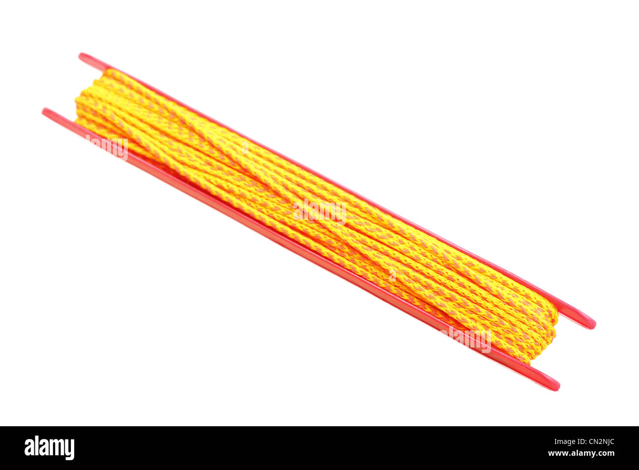 yellow string roll up isolated on white Stock Photo - Alamy