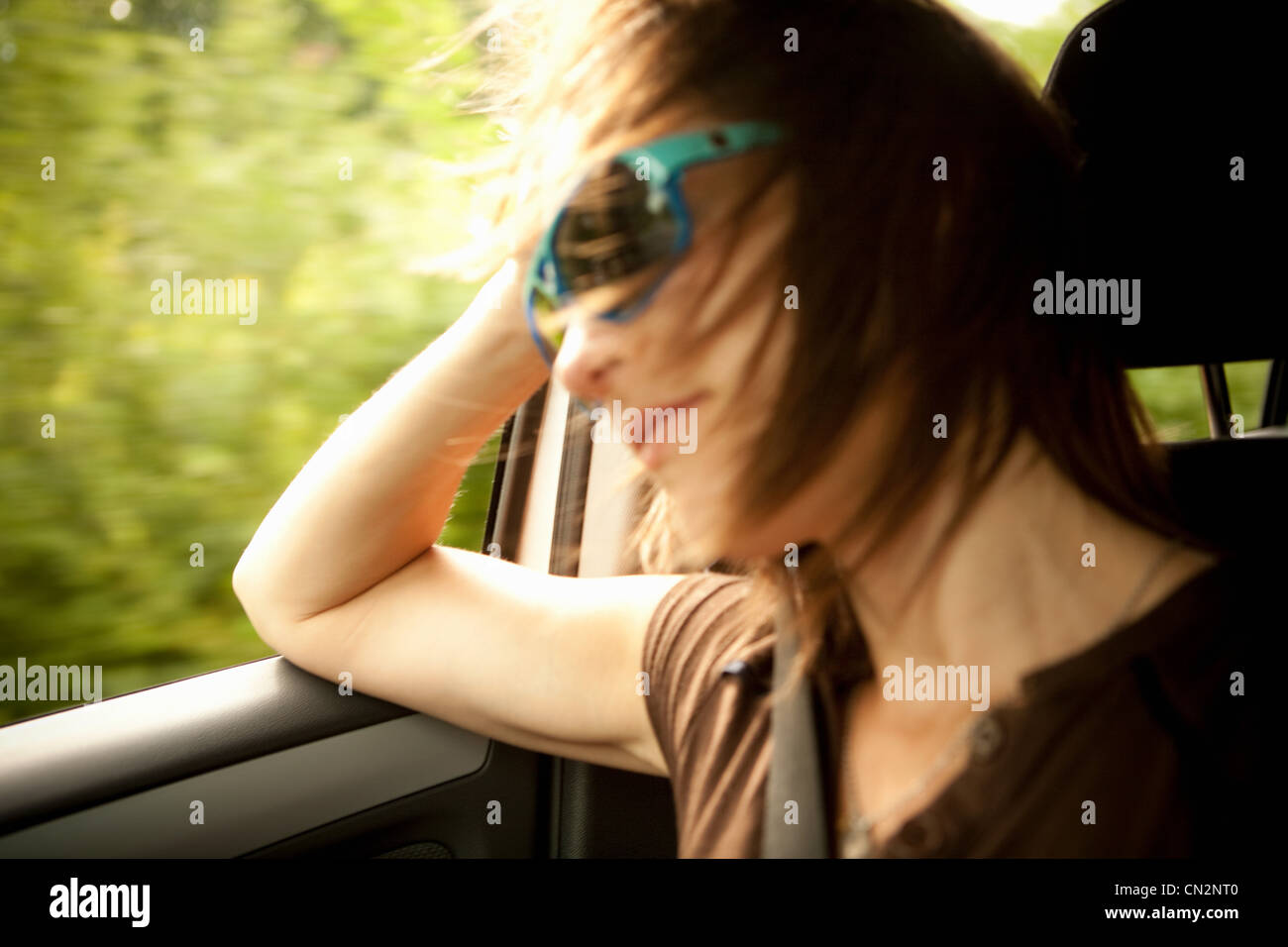 Female passenger in car with window open Stock Photo - Alamy