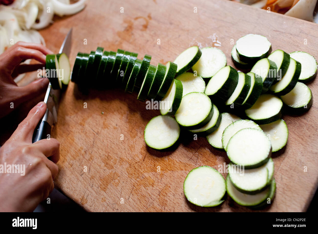 Person chopping courgette Stock Photo - Alamy