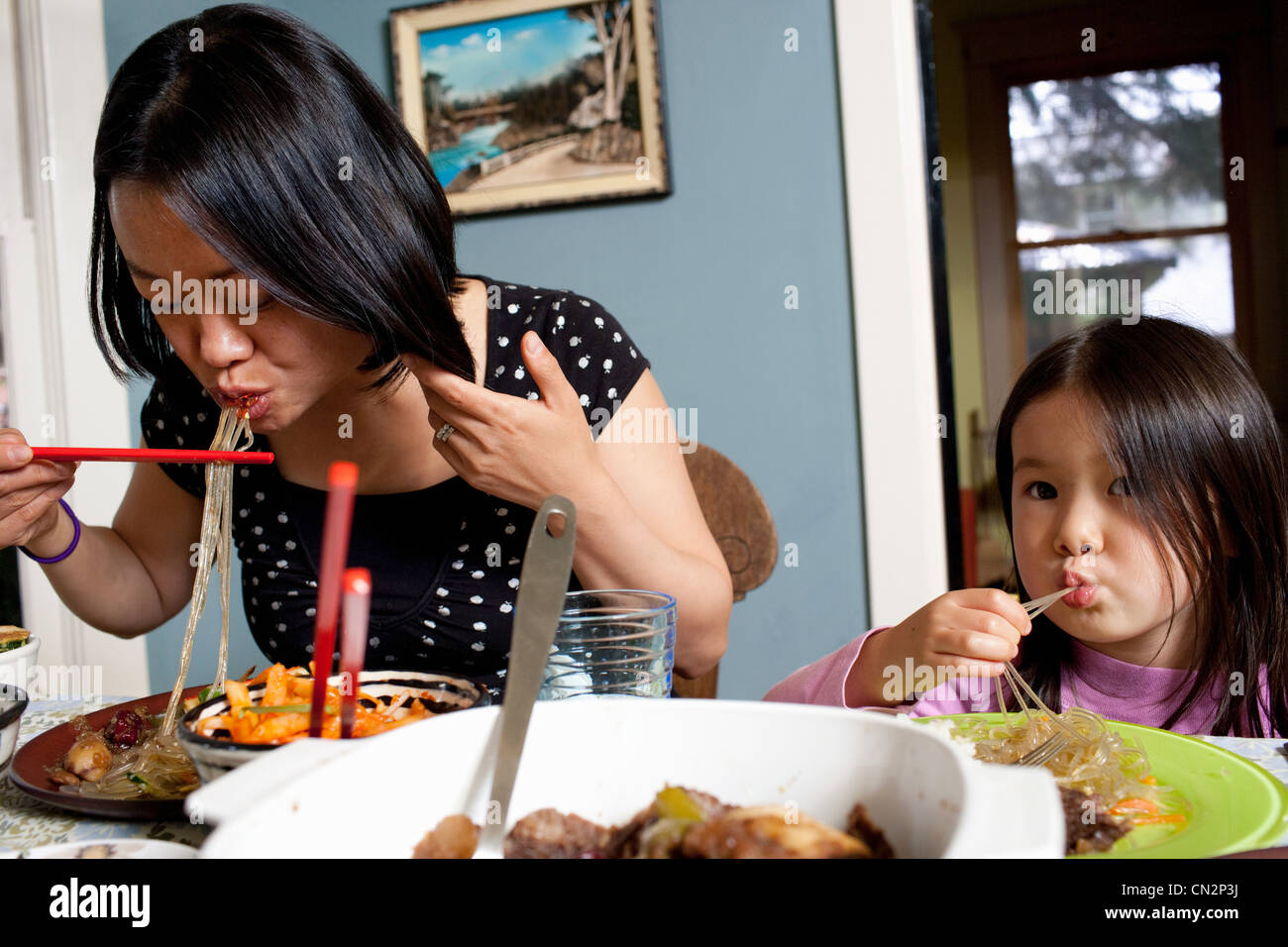 Mother and daughter eating meal Stock Photo - Alamy