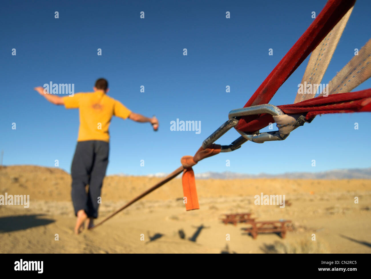 Man balancing on a tightrope Stock Photo - Alamy
