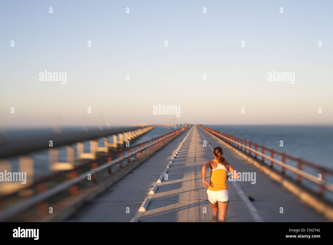 Woman Running on Bridge Over Ocean, Selective Focus, Rear View, Florida ...