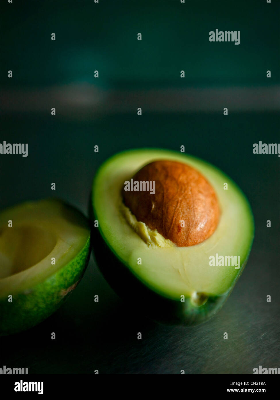 Avocado cut in half Stock Photo - Alamy