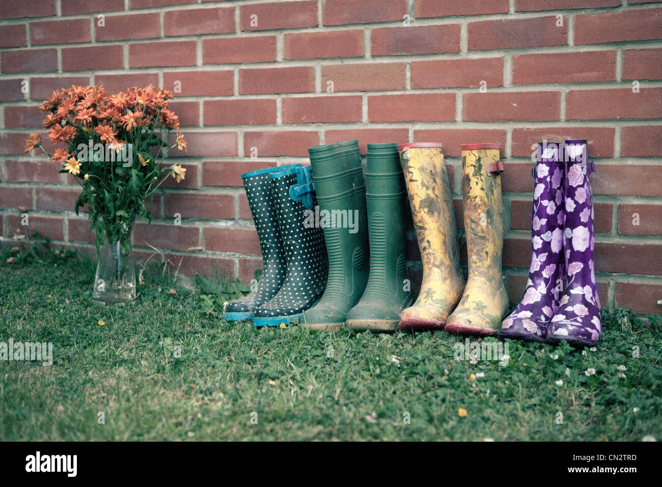 Wellington boots by brick wall Stock Photo - Alamy