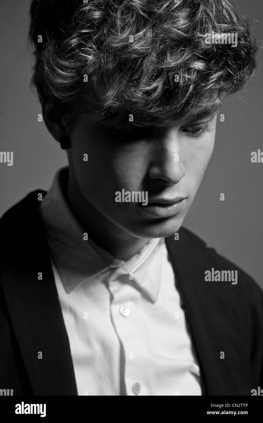 Portrait of young man looking down Stock Photo - Alamy