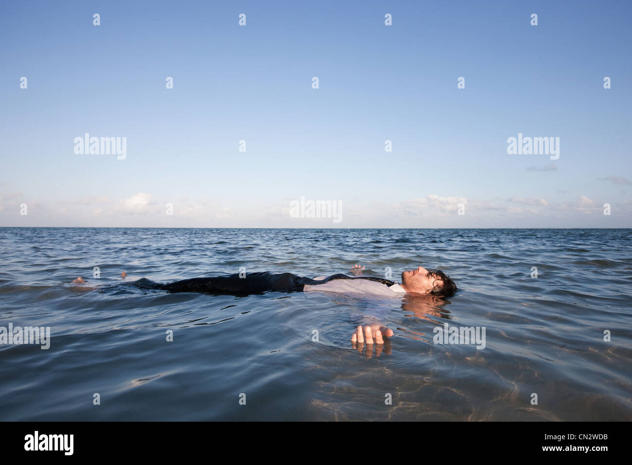 Businessman floating in sea Stock Photo - Alamy