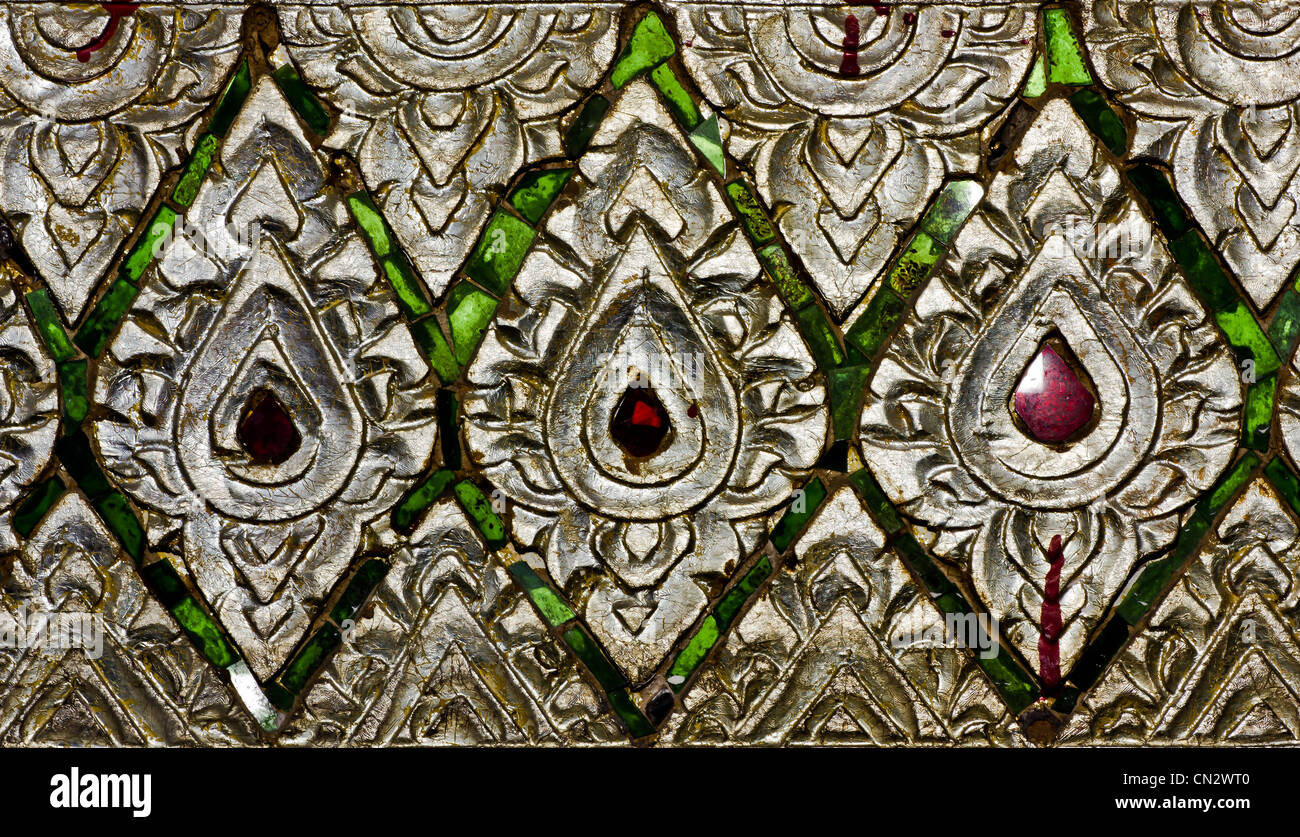 Native art carved on the wall in the temple Stock Photo - Alamy