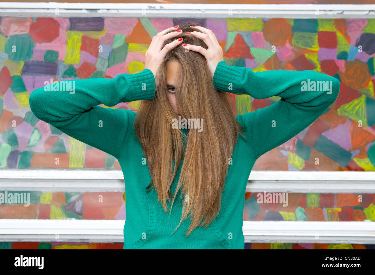 Teenage girl with hands in hair Stock Photo - Alamy