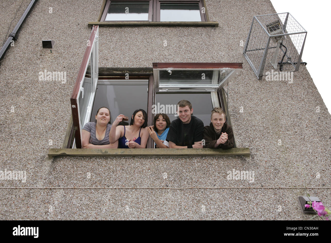 Five children looking out of window Stock Photo - Alamy
