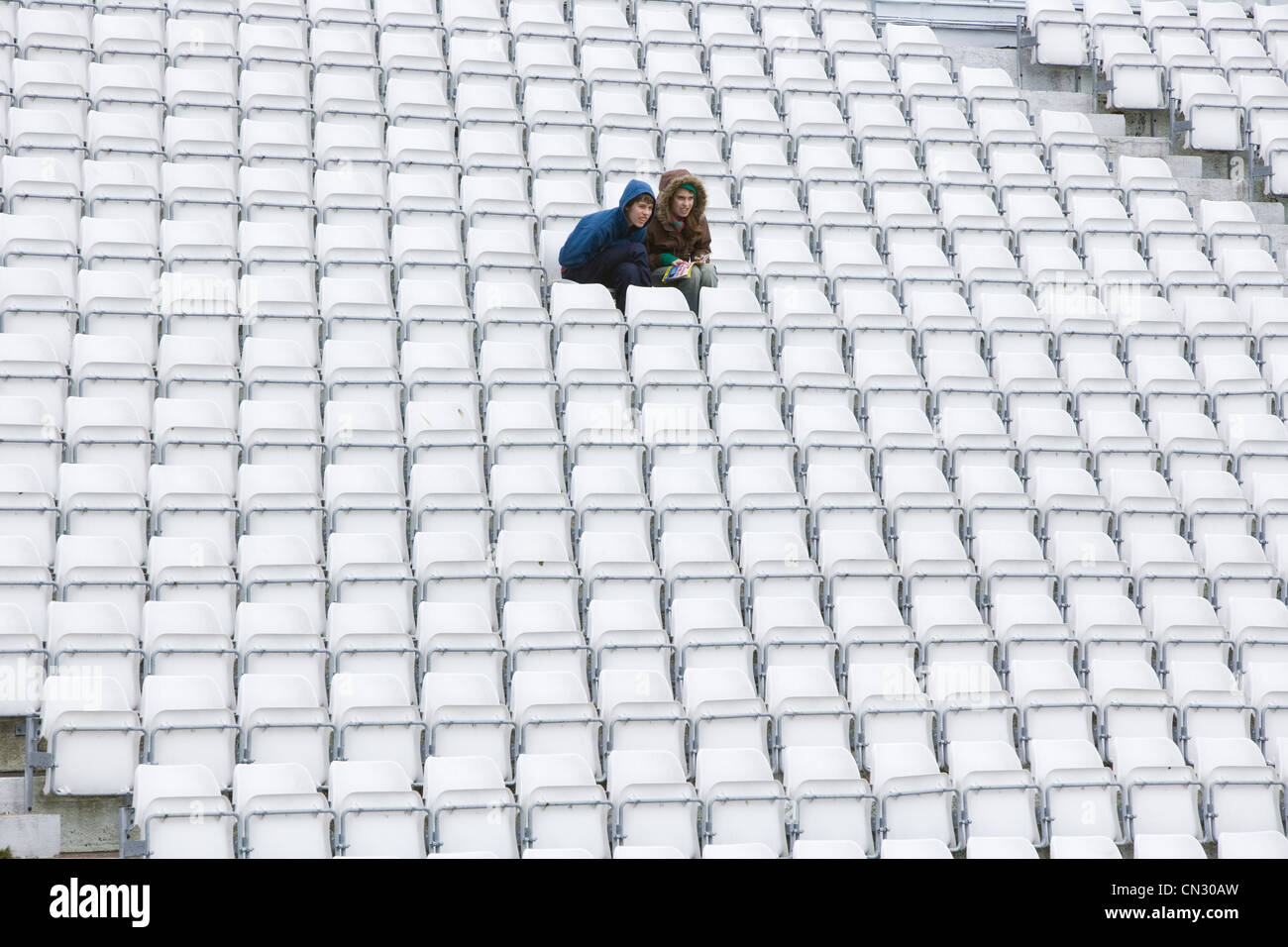 Couple sitting on stadium seats Stock Photo - Alamy