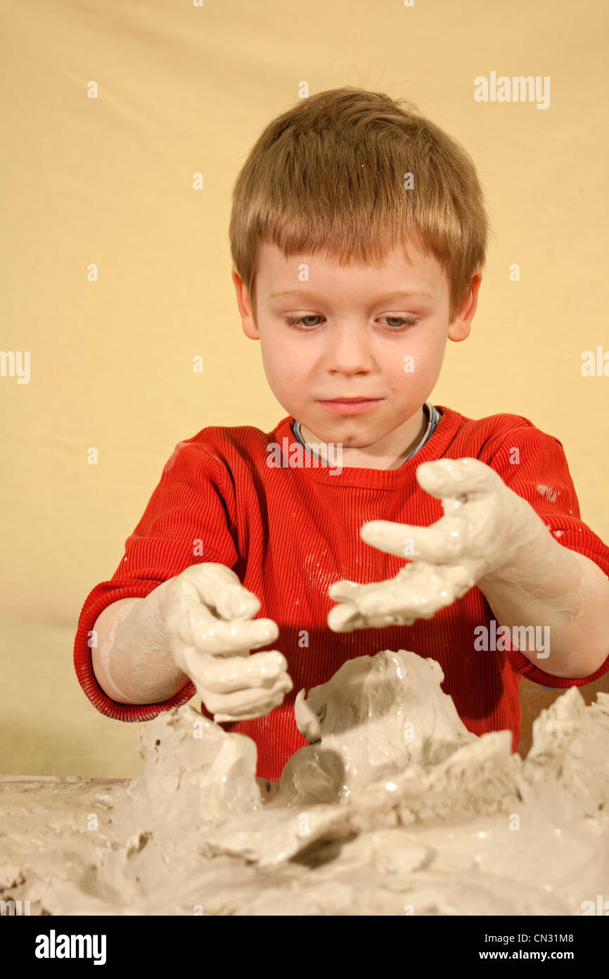young boy working at the clay-field Stock Photo - Alamy