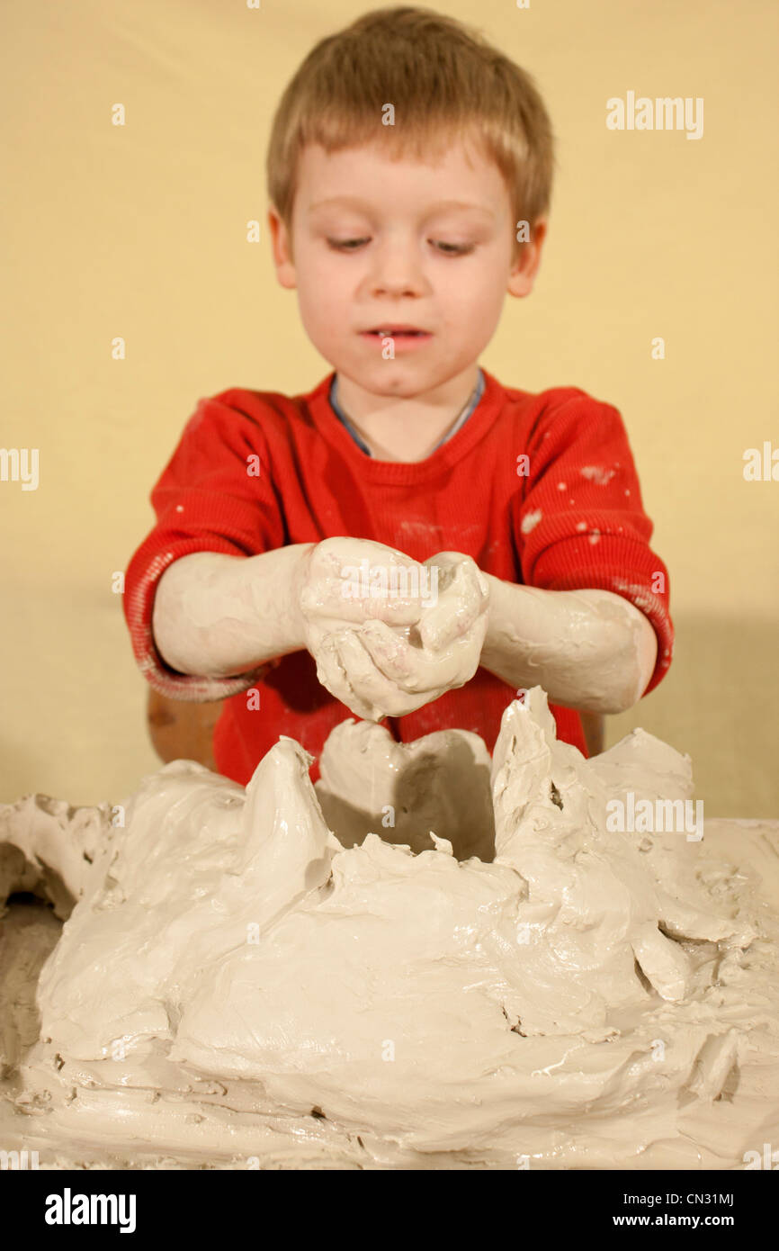 young boy working at the clay-field Stock Photo - Alamy