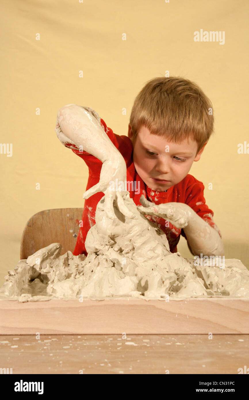 young boy working at the clay-field Stock Photo - Alamy