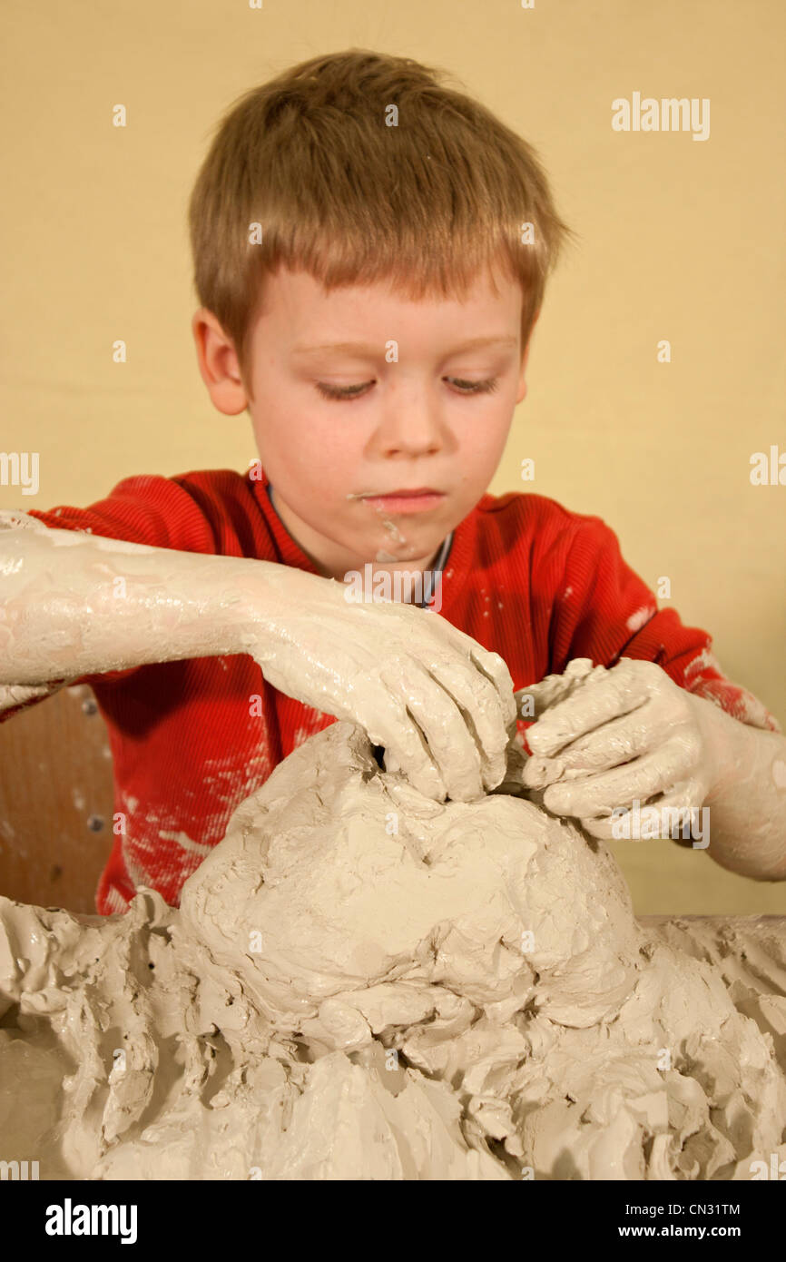 young boy working at the clay-field Stock Photo - Alamy