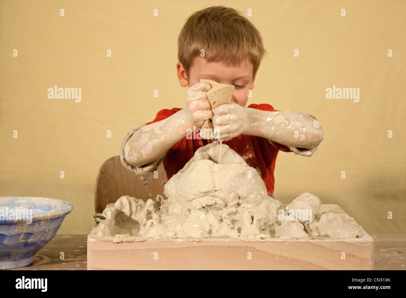 young boy working at the clay-field Stock Photo - Alamy
