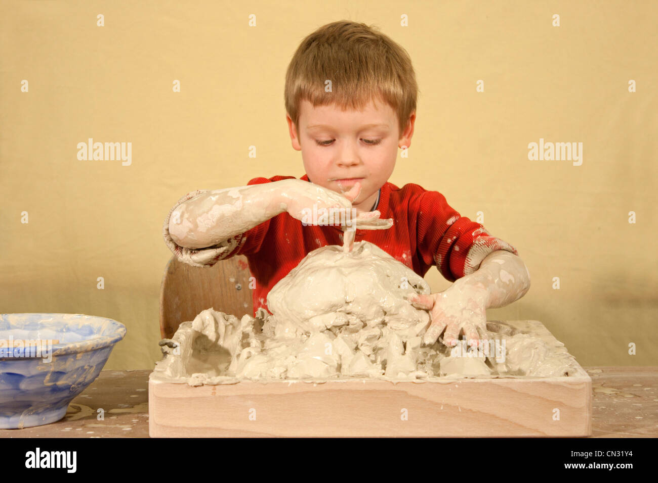young boy working at the clay-field Stock Photo - Alamy