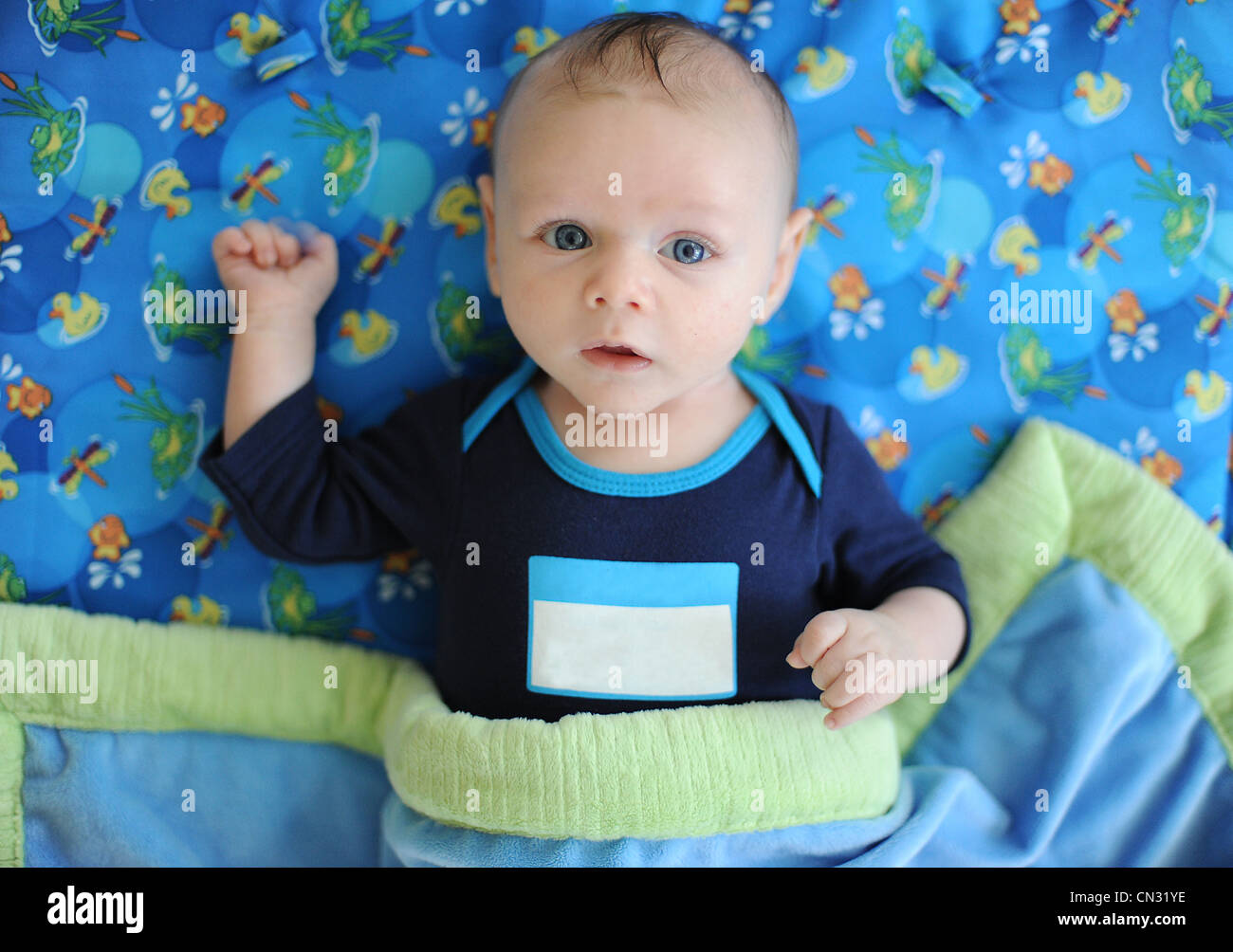 Baby boy lying in cot Stock Photo - Alamy