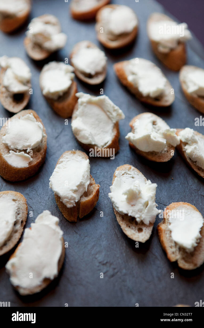 Goats cheese on baguette slices Stock Photo - Alamy