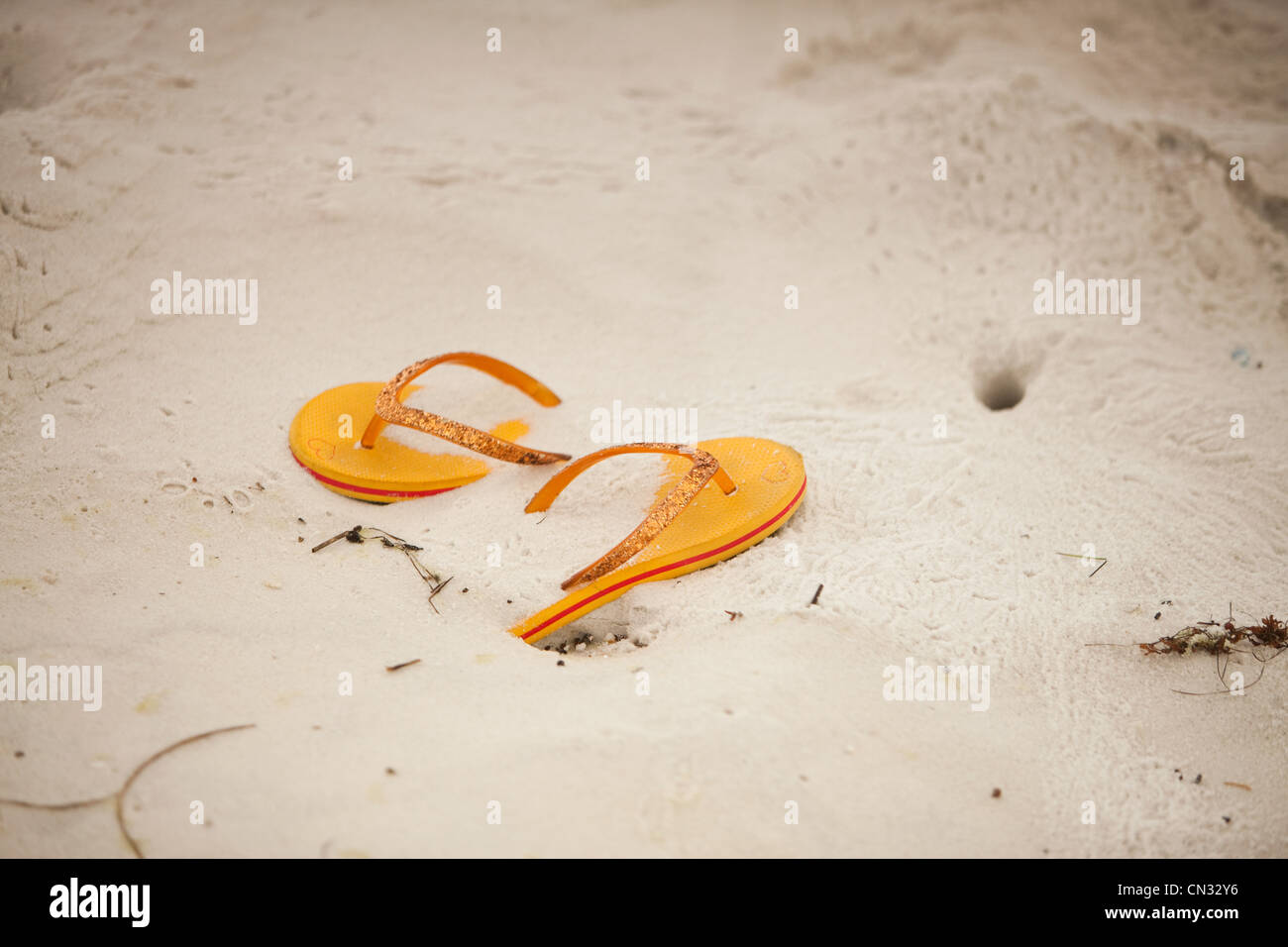 Flip flops in sand Stock Photo - Alamy