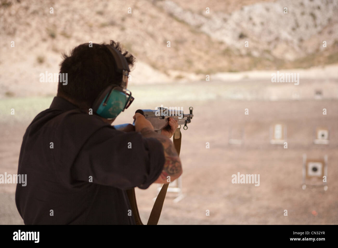 Man shooting rifle at target Stock Photo - Alamy