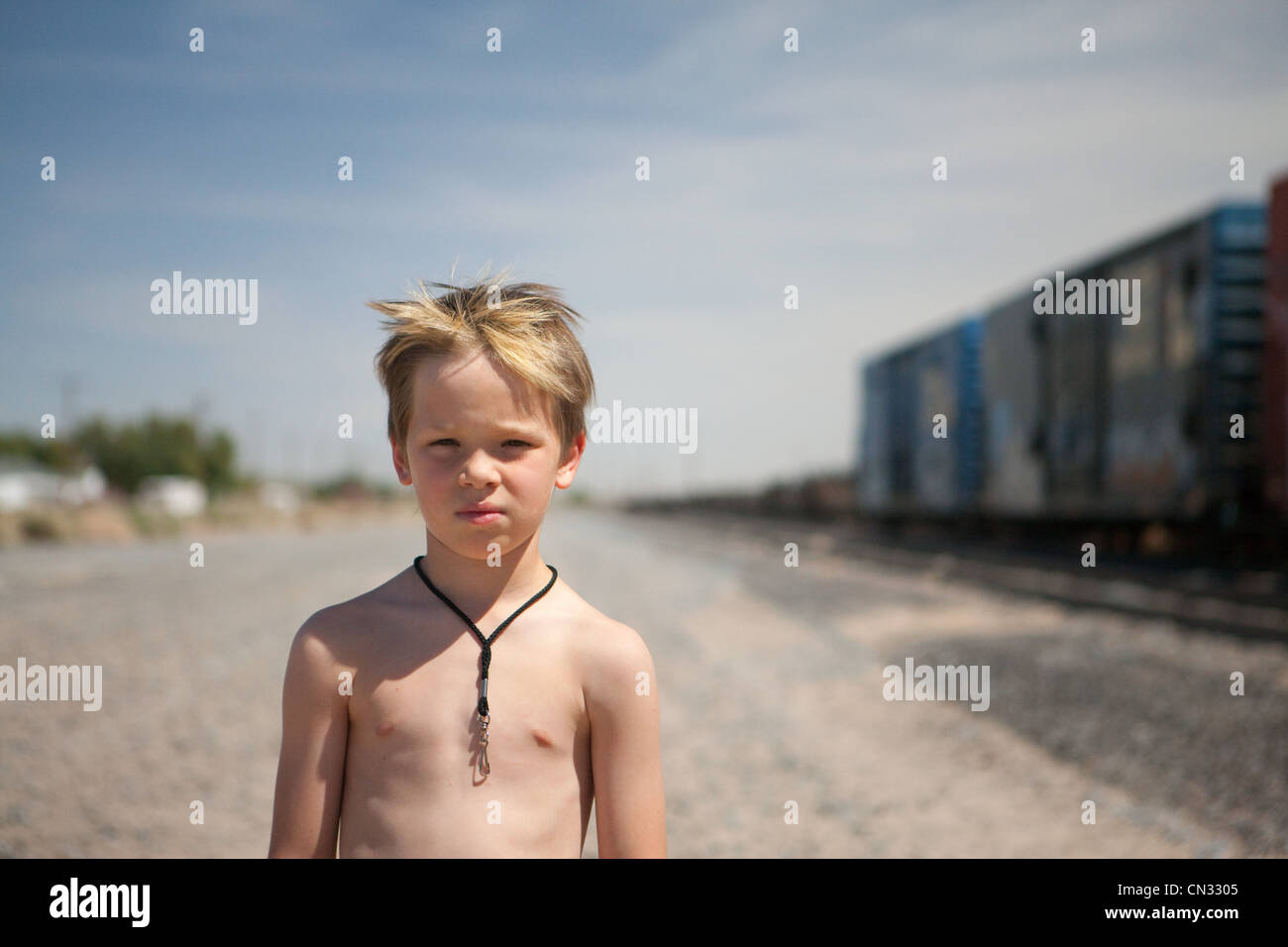 Boy by train tracks Stock Photo - Alamy