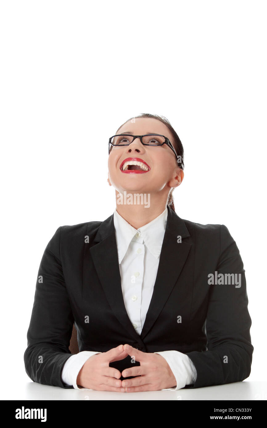 Young happy businesswoman behind the desk, looking up, isolated Stock ...