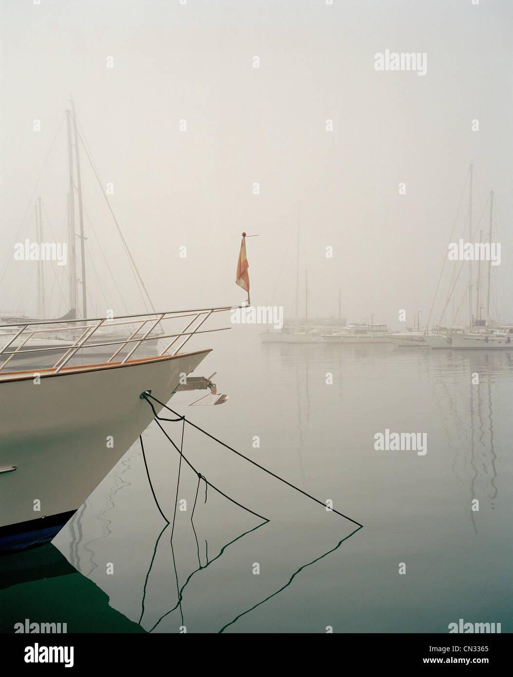 Boats in harbour in fog Stock Photo - Alamy