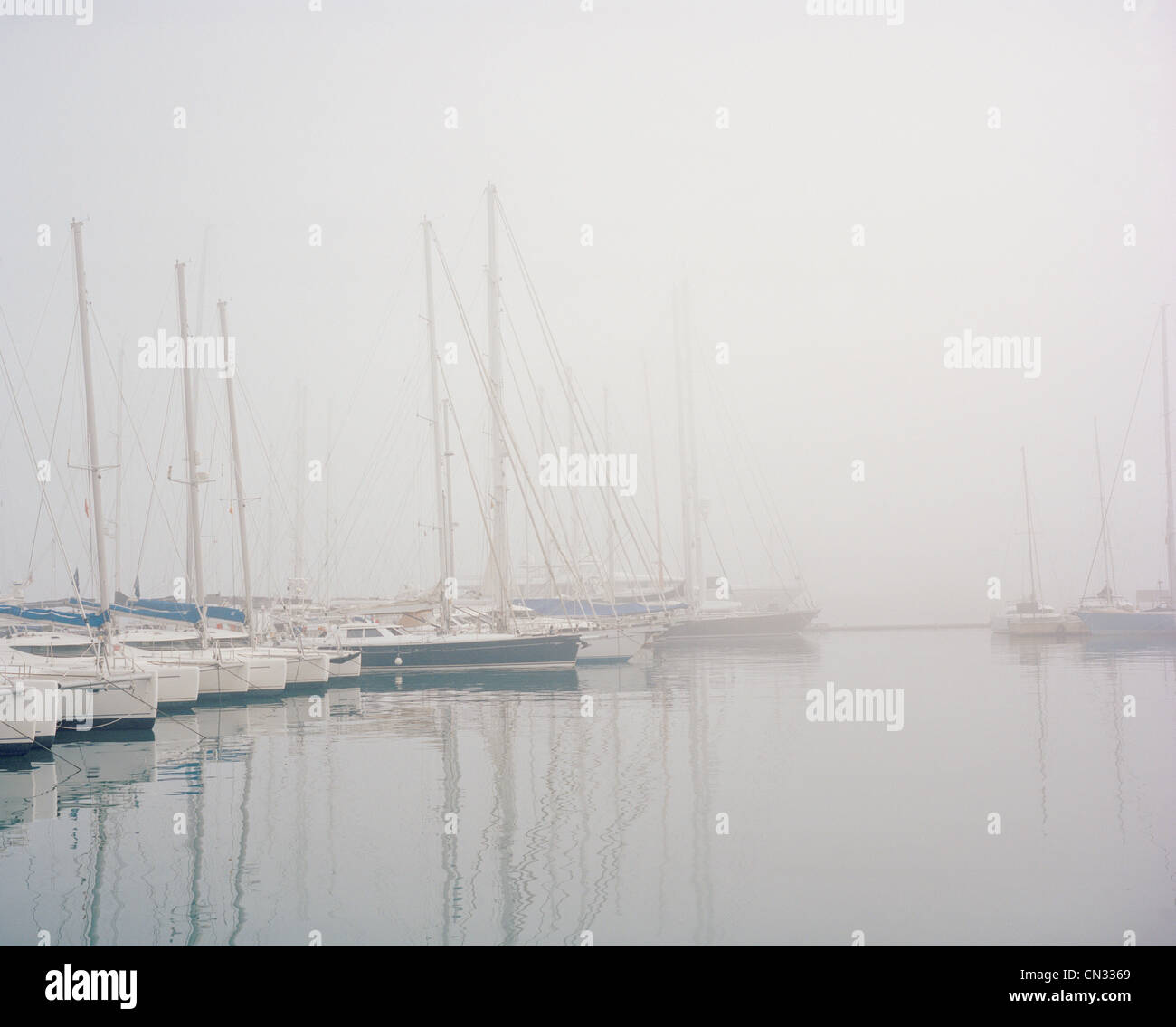 Boats in harbour in fog Stock Photo - Alamy