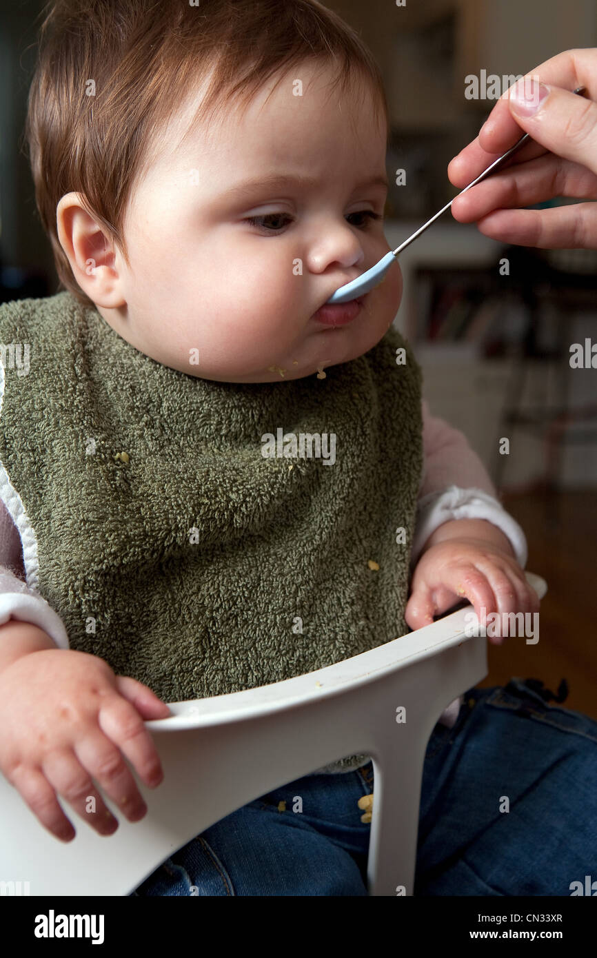 Baby girl being fed Stock Photo - Alamy