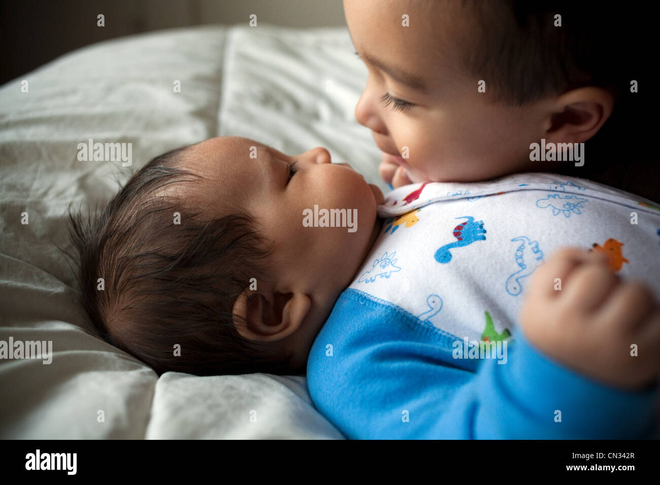 Boy with baby brother, close up Stock Photo - Alamy