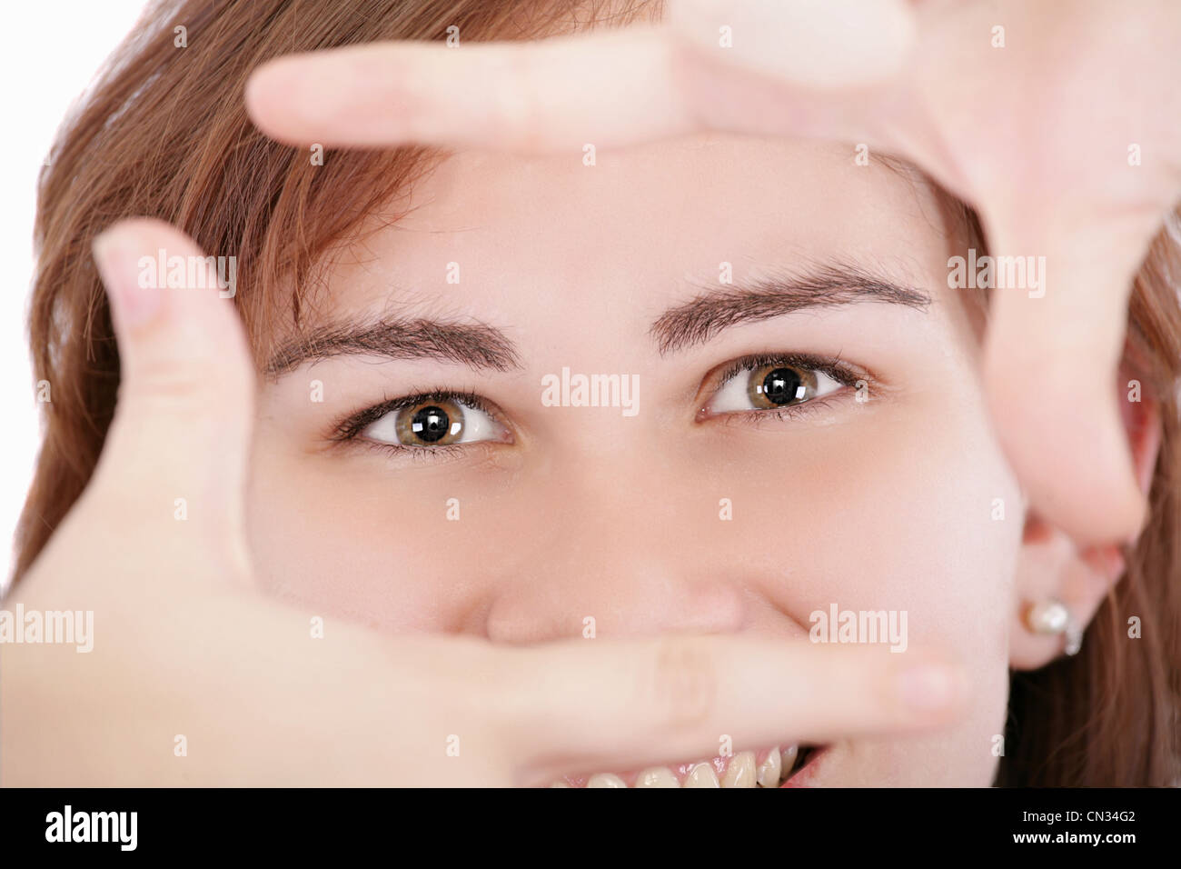 Pretty adult woman looking through a frame made by her hands Stock ...