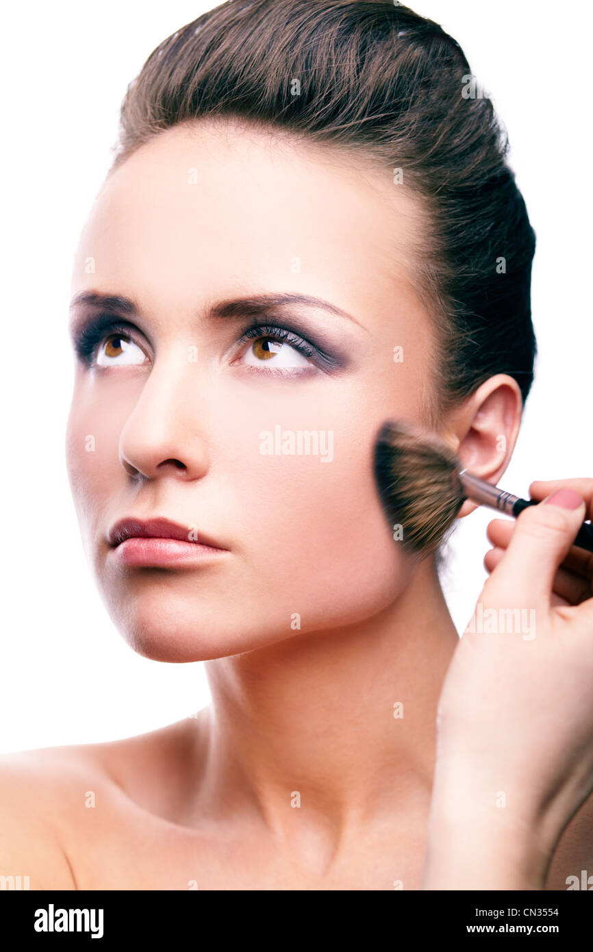 Image of gorgeous woman applying rouge on her cheek Stock Photo - Alamy
