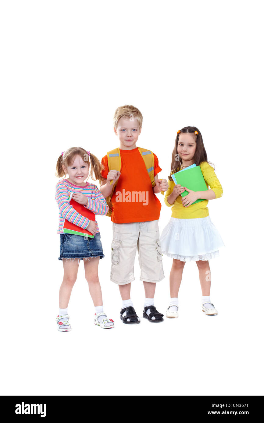 Three school children isolated on white background looking confidently ...