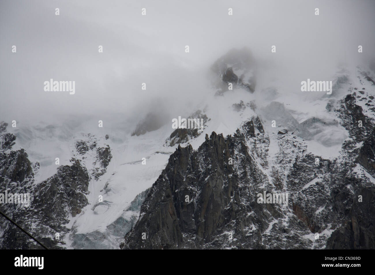 Snow Covered mountains in cloud Stock Photo - Alamy