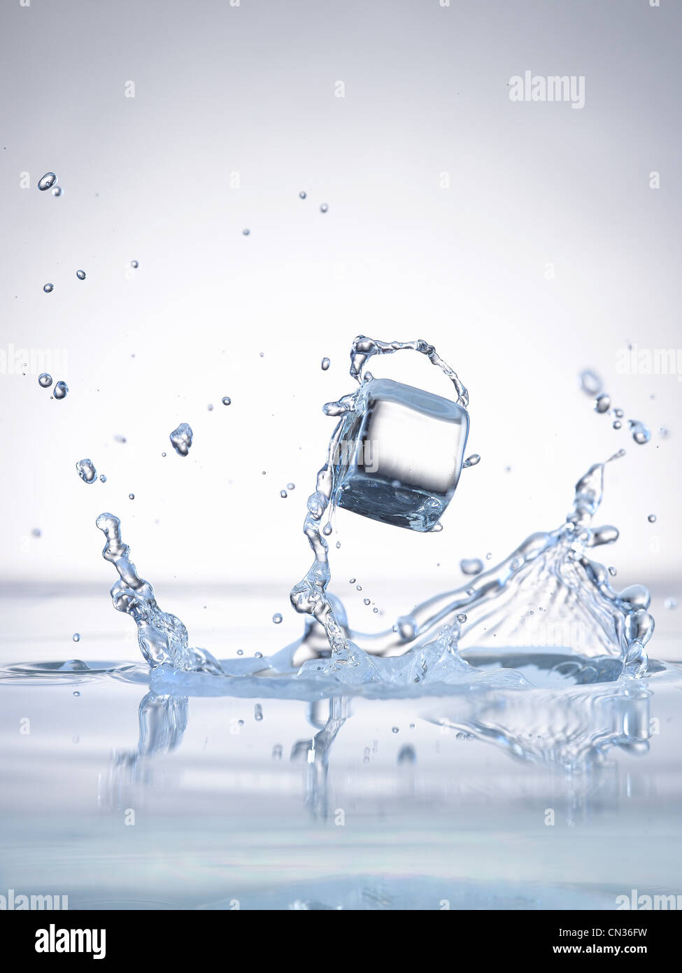 Ice cube splashing in water Stock Photo - Alamy