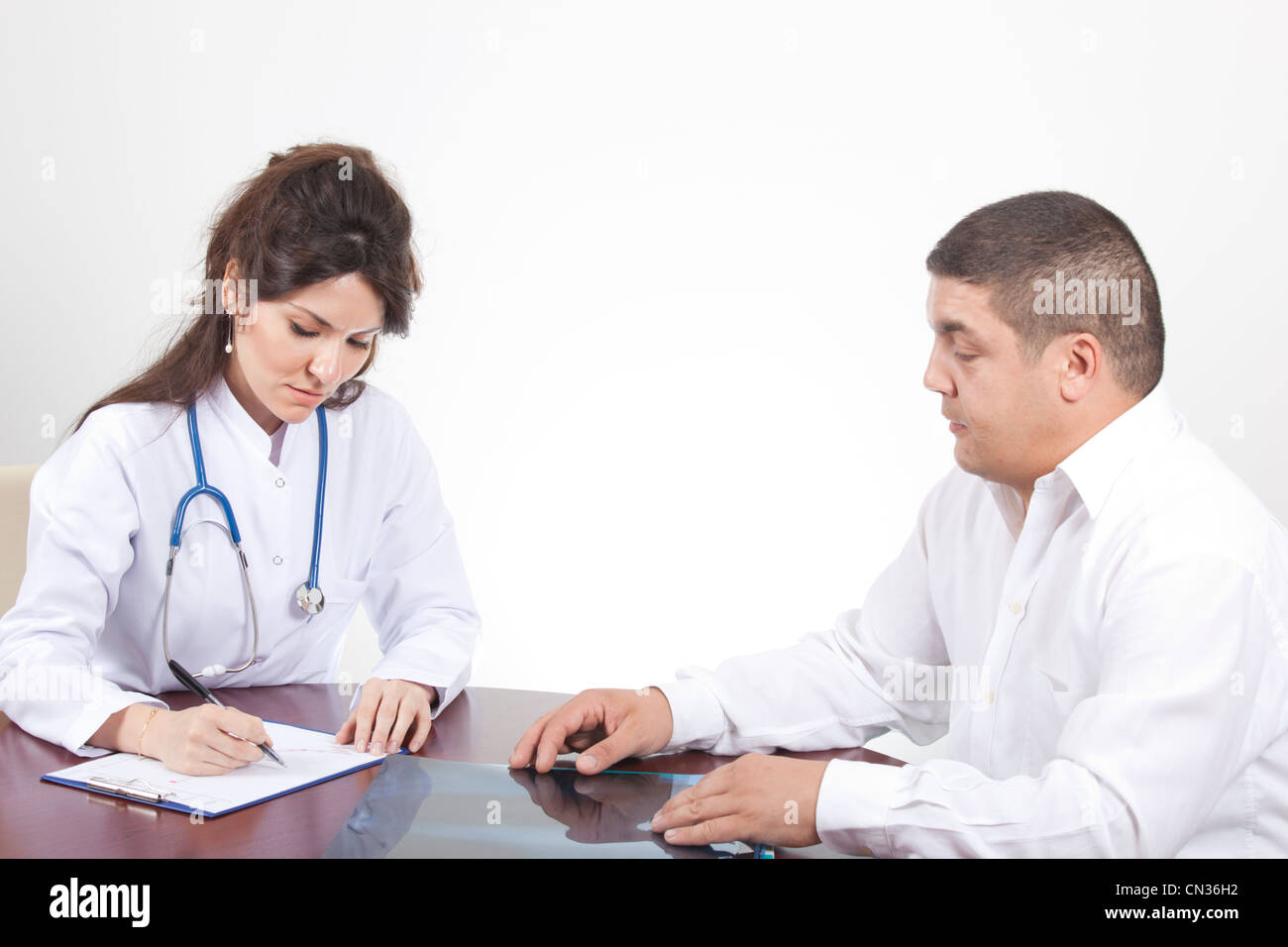 man with doctor sit at table on white Stock Photo - Alamy