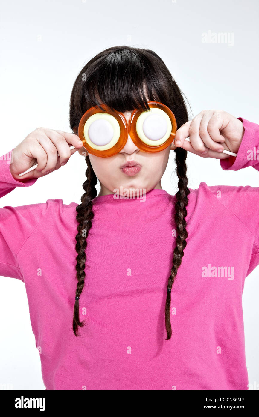 Girl covering eyes with lolipops Stock Photo - Alamy