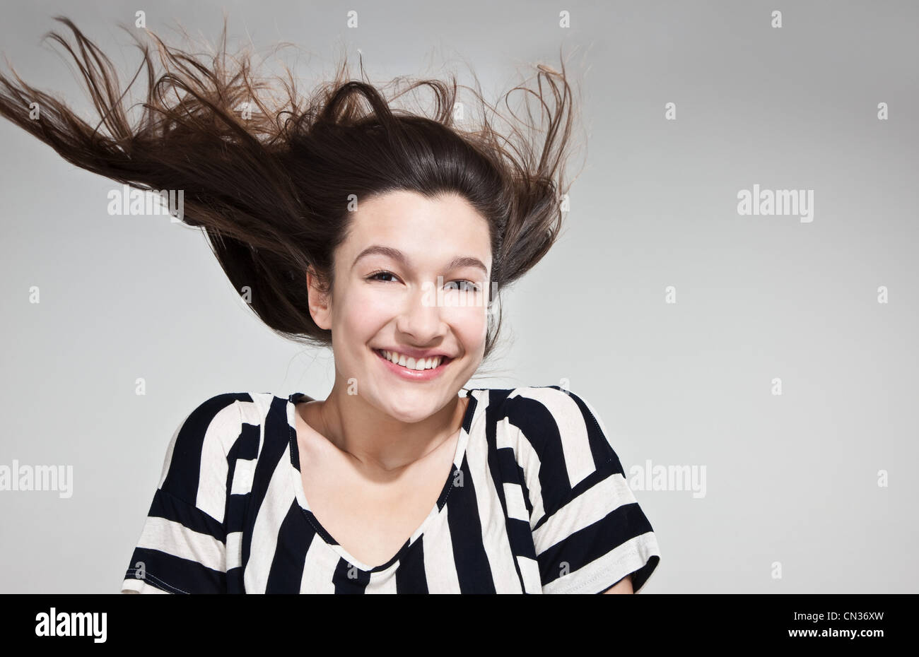 Windswept dark hair teenager hi-res stock photography and images - Alamy