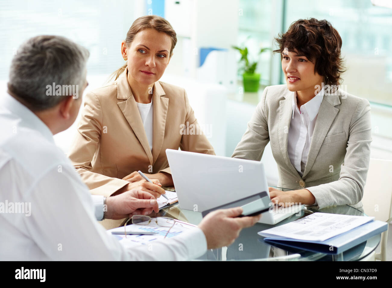 Business women listening attentively to their elder experienced ...