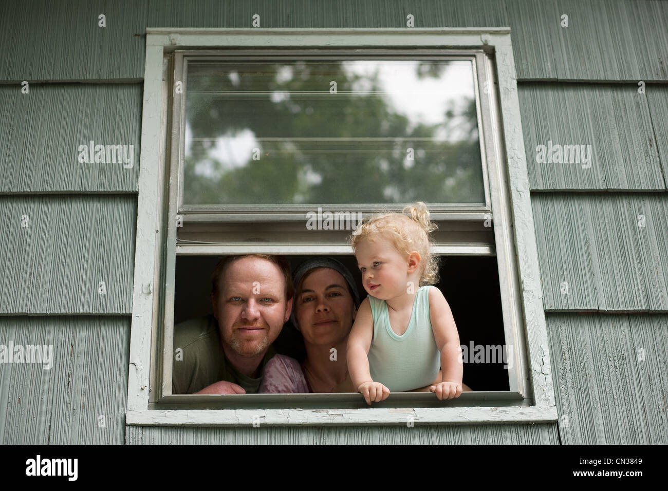 Family looking through window Stock Photo - Alamy