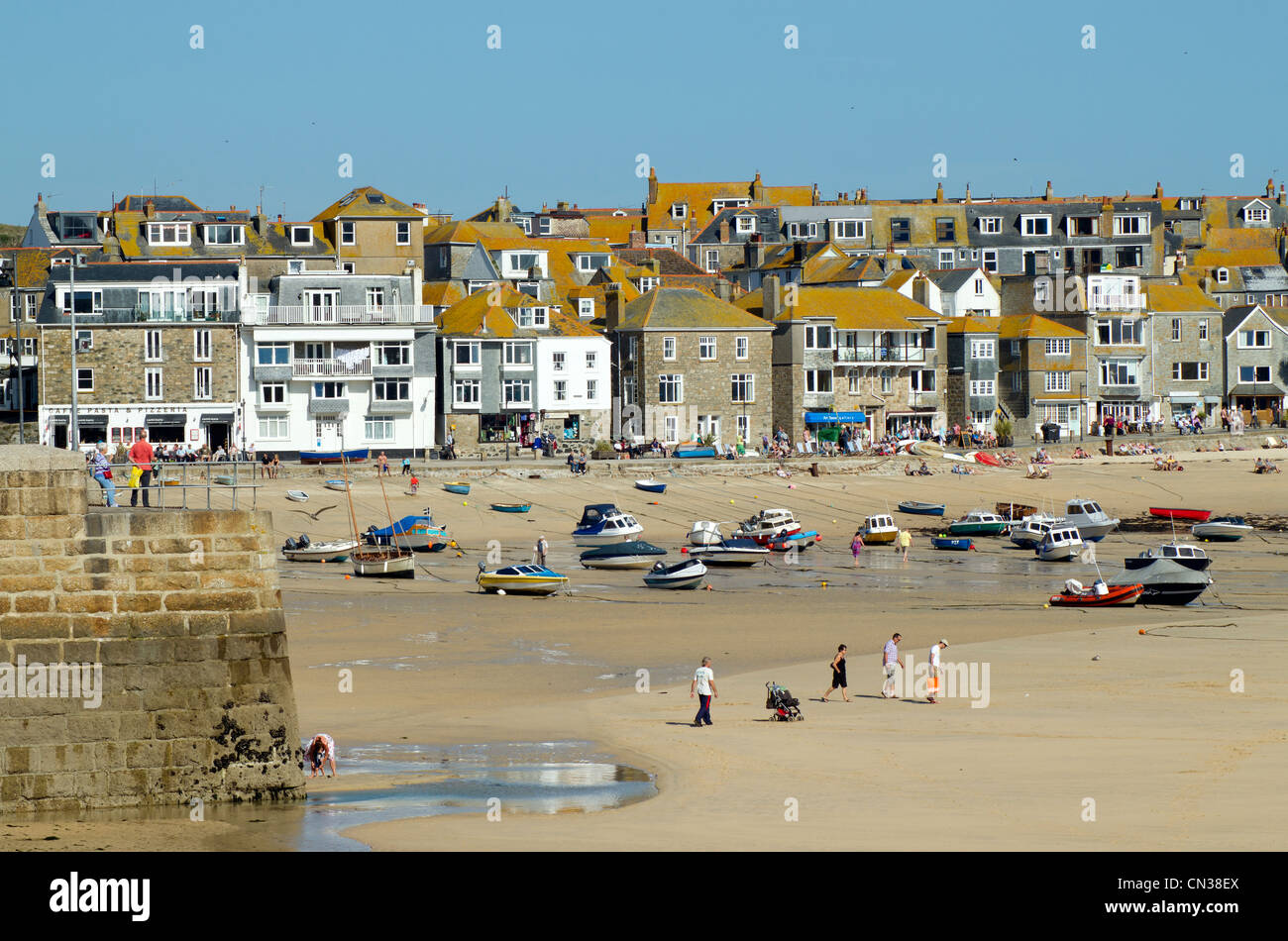 St. Ives sea front harbour beach at low tide with West Pier in the ...
