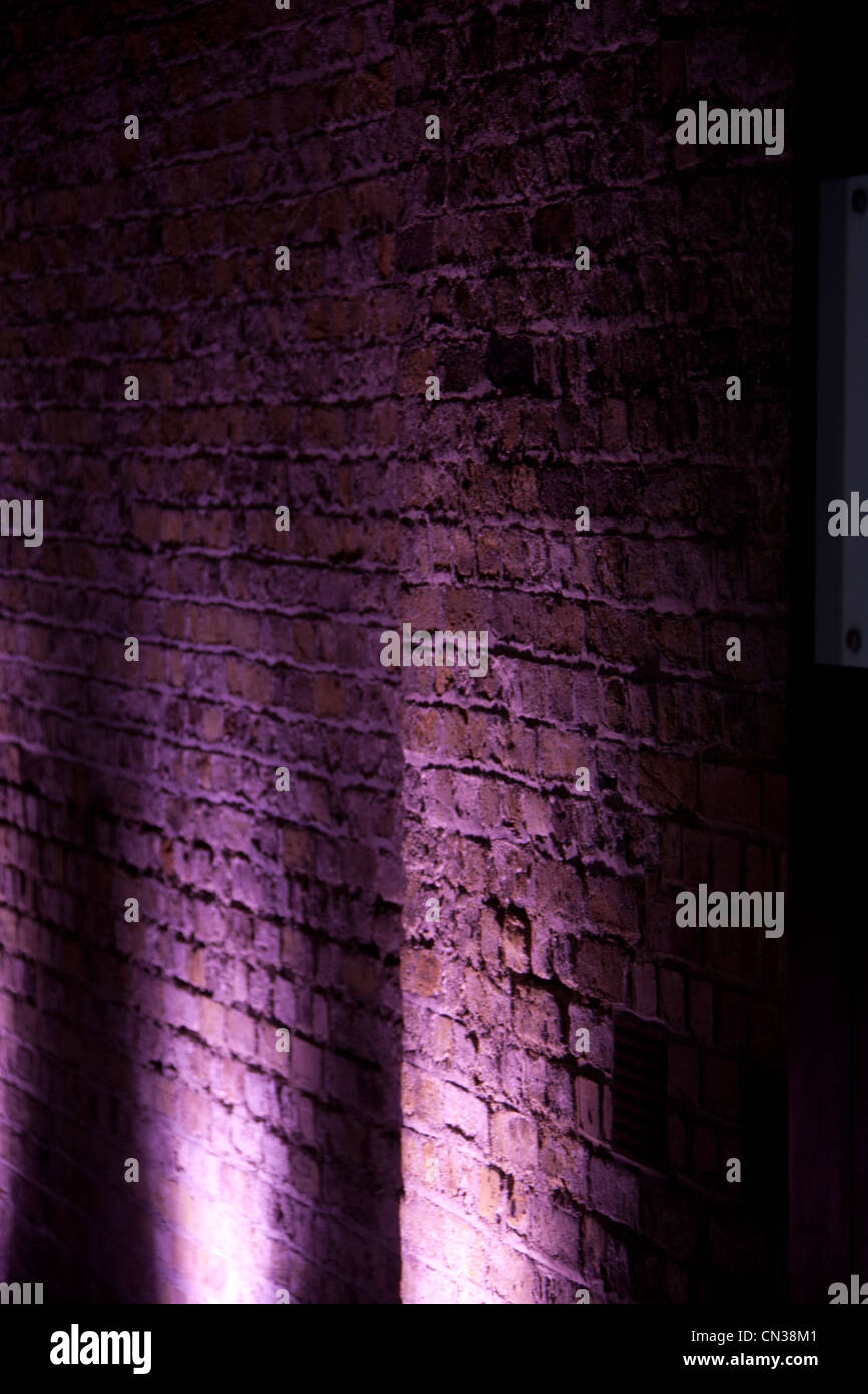 Brick wall at night lit from below Stock Photo - Alamy