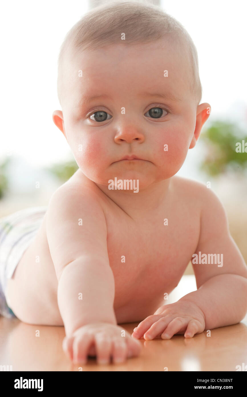 Baby girl lying on her front Stock Photo - Alamy