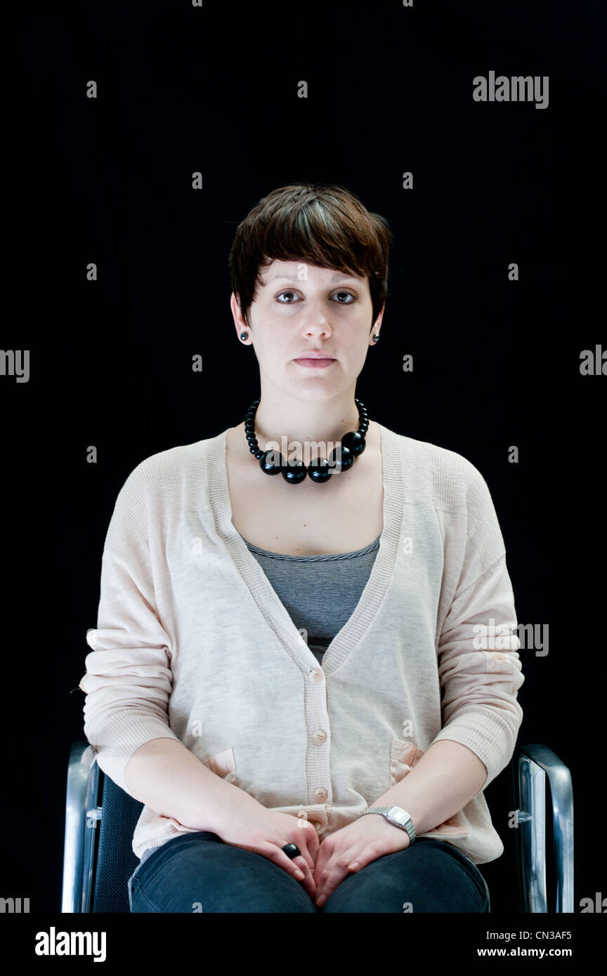Woman sitting in chair, portrait Stock Photo - Alamy