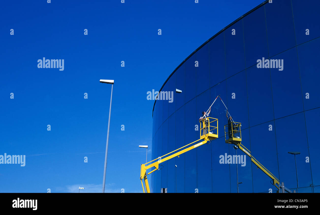 Person in access platform cleaning office window Stock Photo - Alamy