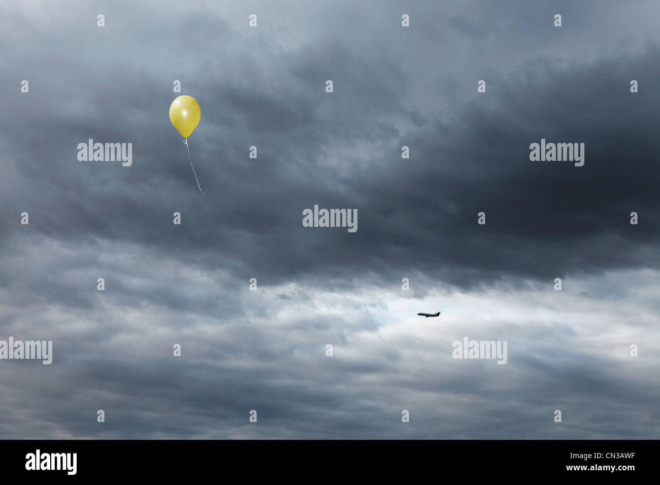 Yellow balloon floating toward cloudy sky Stock Photo - Alamy
