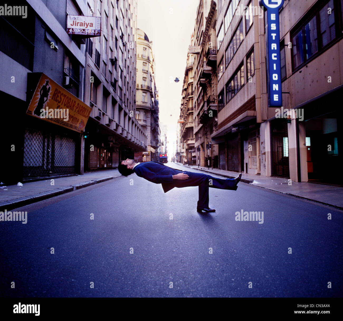 Businessman floating above city street Stock Photo - Alamy