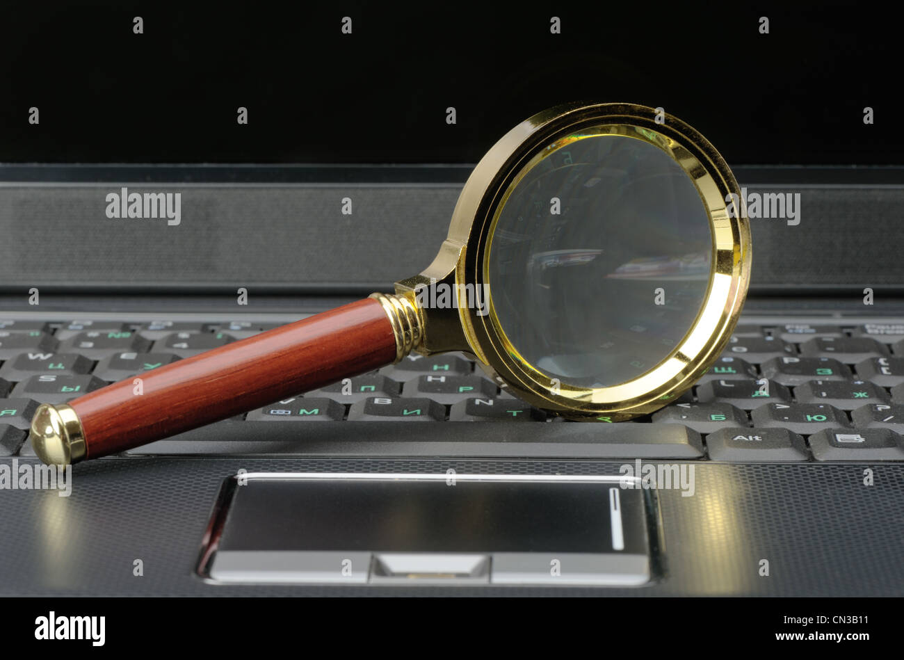 Magnifying glass and a laptop. The concept of search Stock Photo - Alamy