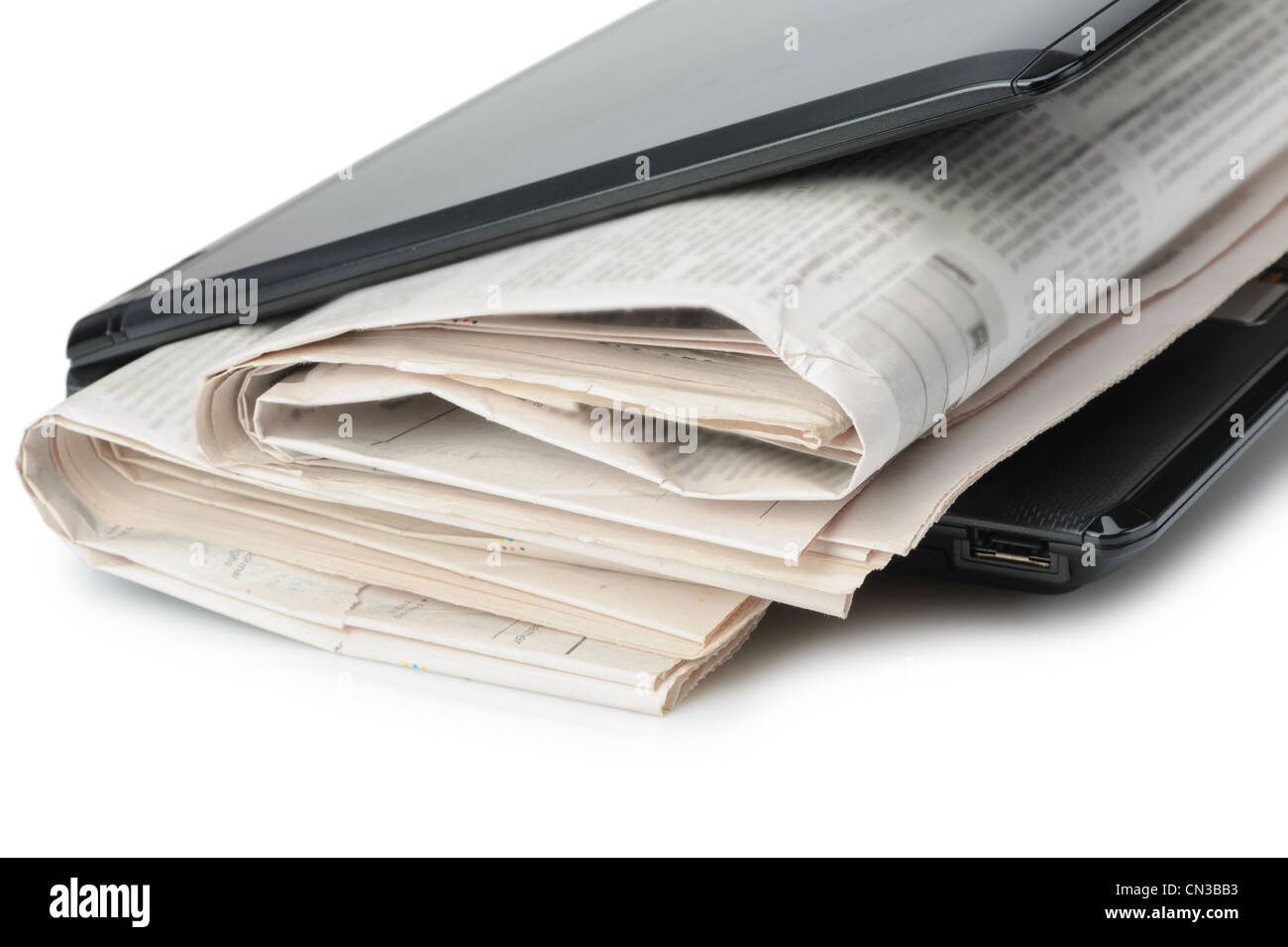 Newspaper and a laptop. The concept of e-news Stock Photo - Alamy