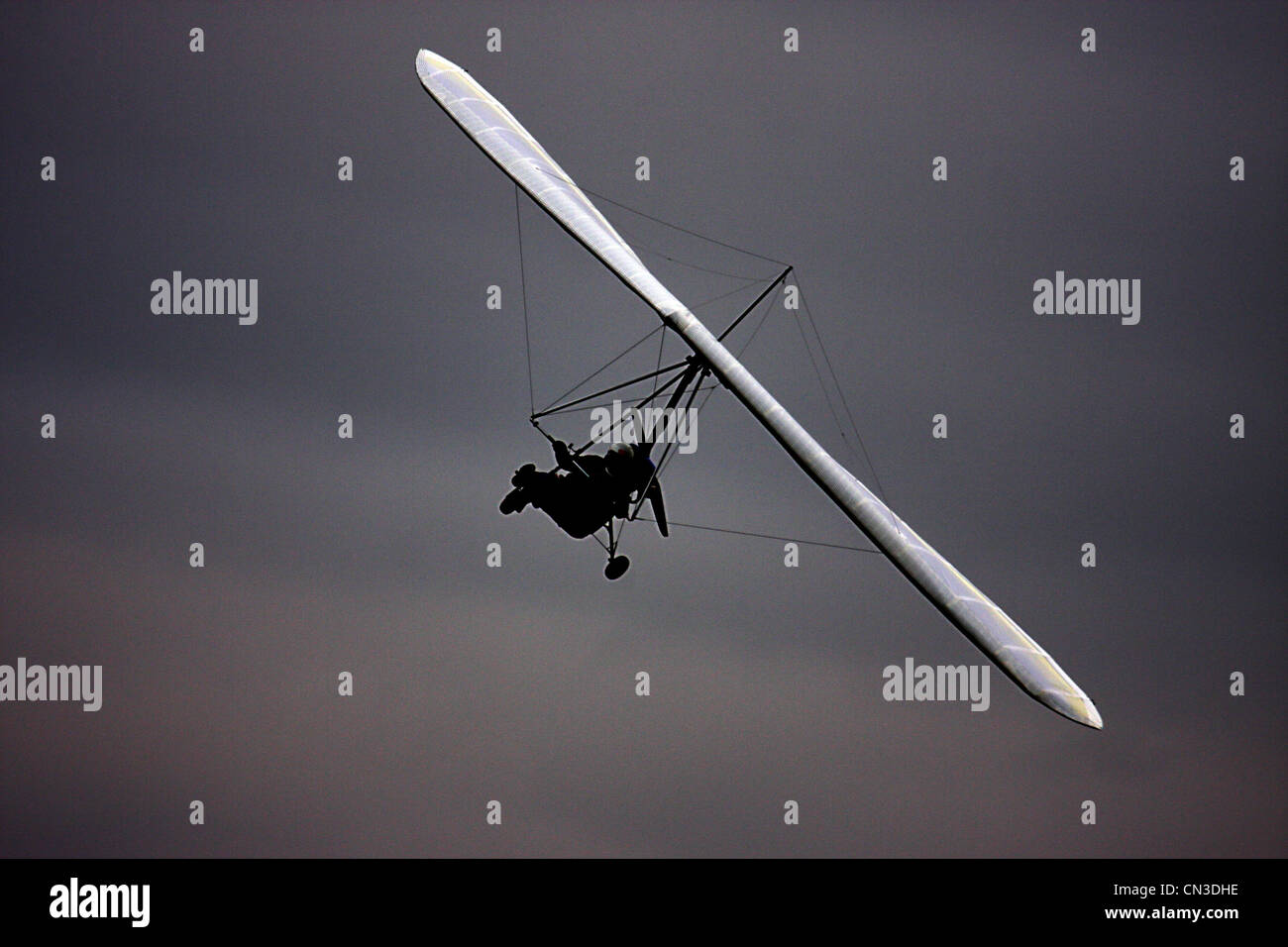 Flexwing microlight silhouetted against a dark sky Stock Photo - Alamy